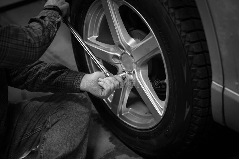 Change and fix car wheel stock photo. Image of worker - 106181050