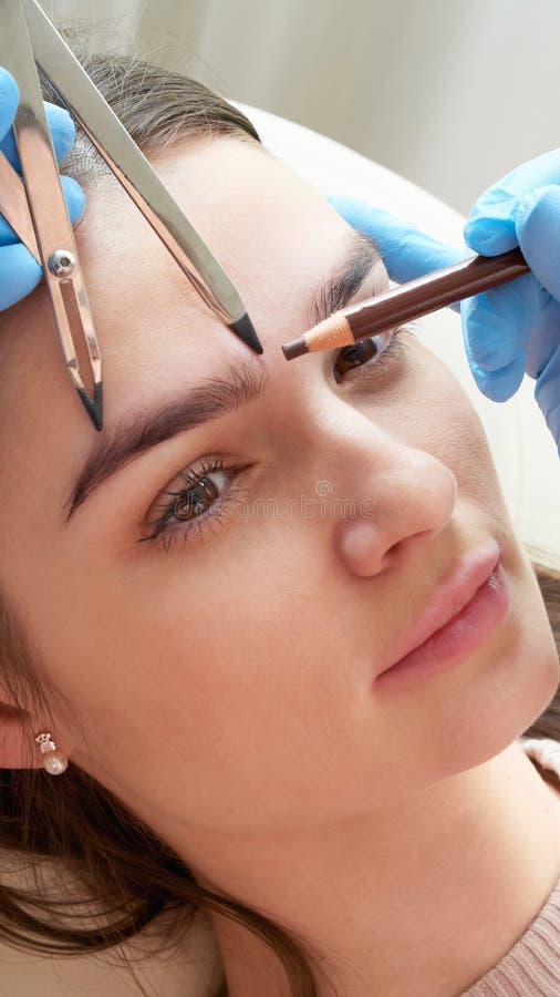 Cosmetologist Measures the Proportions of the Eyebrows with the Ruler ...