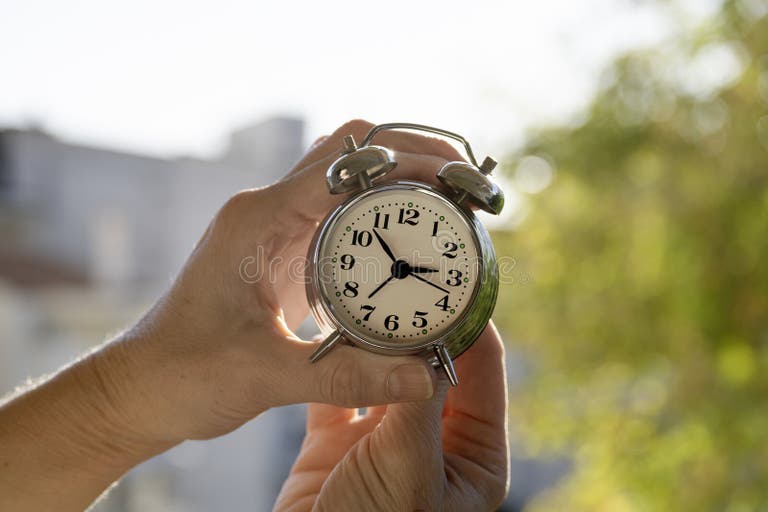 Changing the time on clock stock photo. Image of changing - 338893054