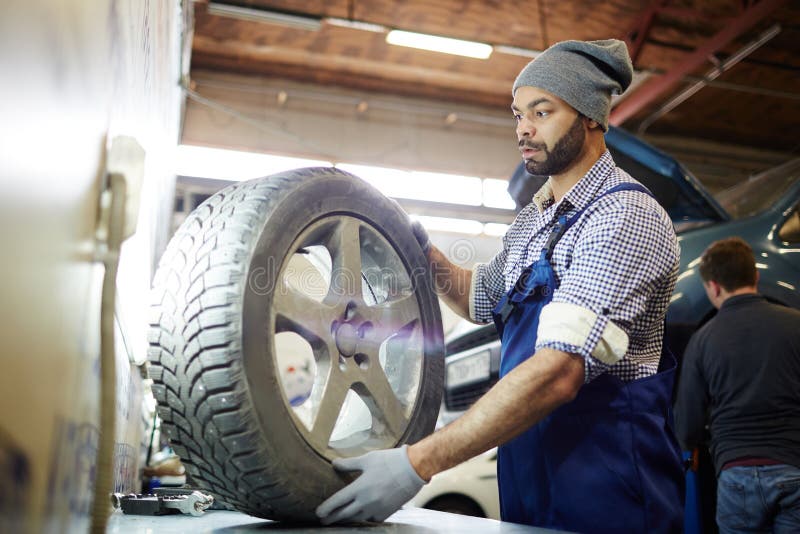 Changing tire stock photo. Image of uniform, carinspection - 93683316