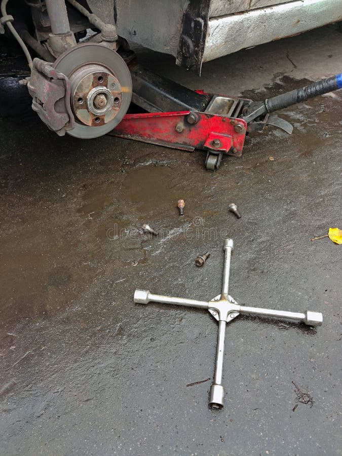 Changing a Wheel on a Car Jack at a Car Service Station Stock Image ...