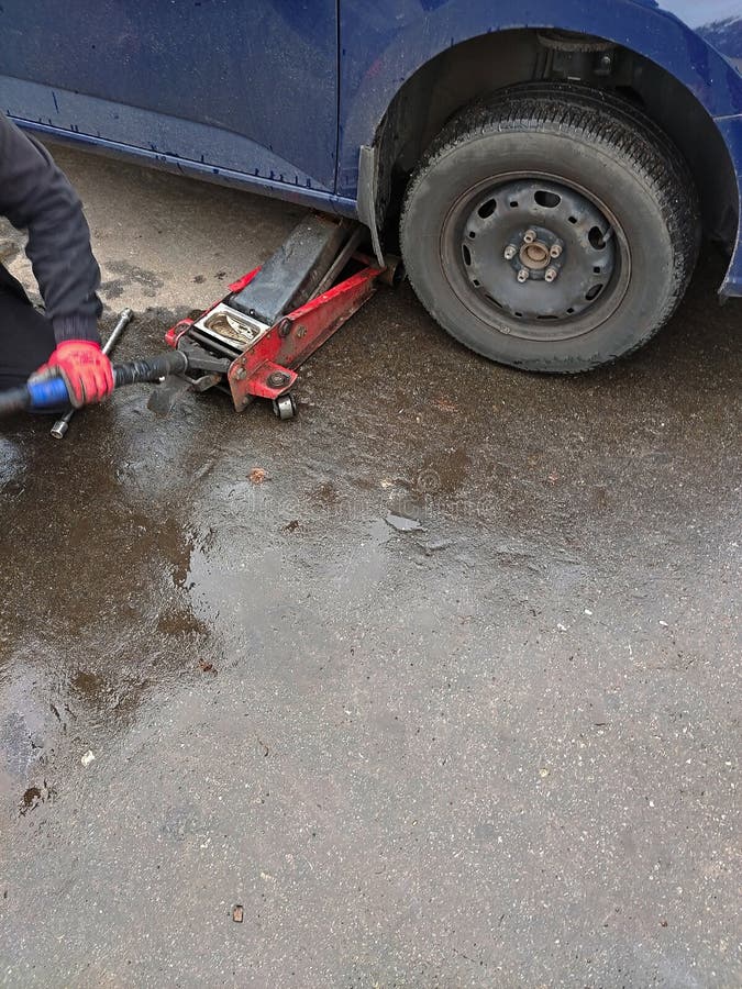 Changing a Wheel on a Car Jack at a Car Service Station Stock Photo ...