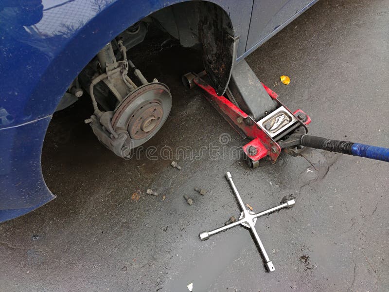 Changing a Wheel on a Car Jack at a Car Service Station Stock Image ...