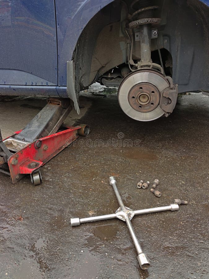Changing a Wheel on a Car Jack at a Car Service Station Stock Image ...
