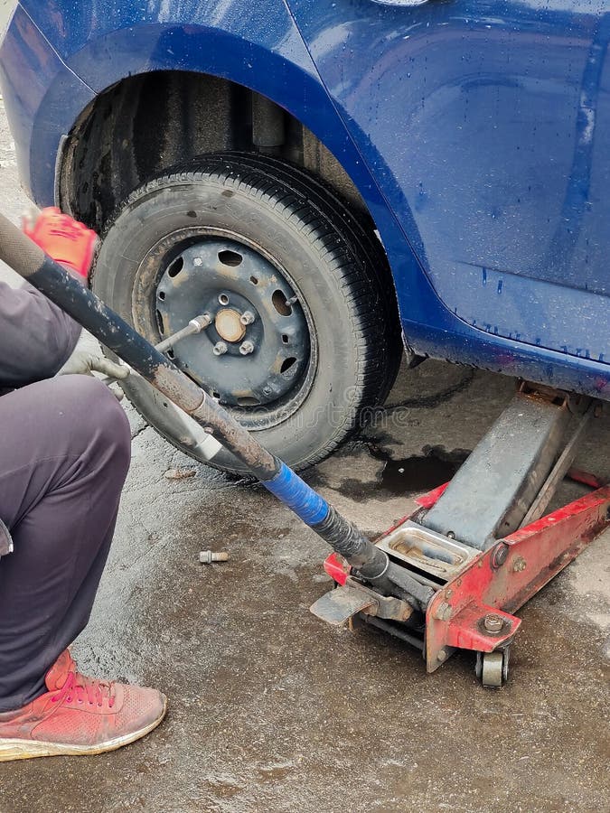Changing a Wheel on a Car Jack at a Car Service Station Stock Photo ...