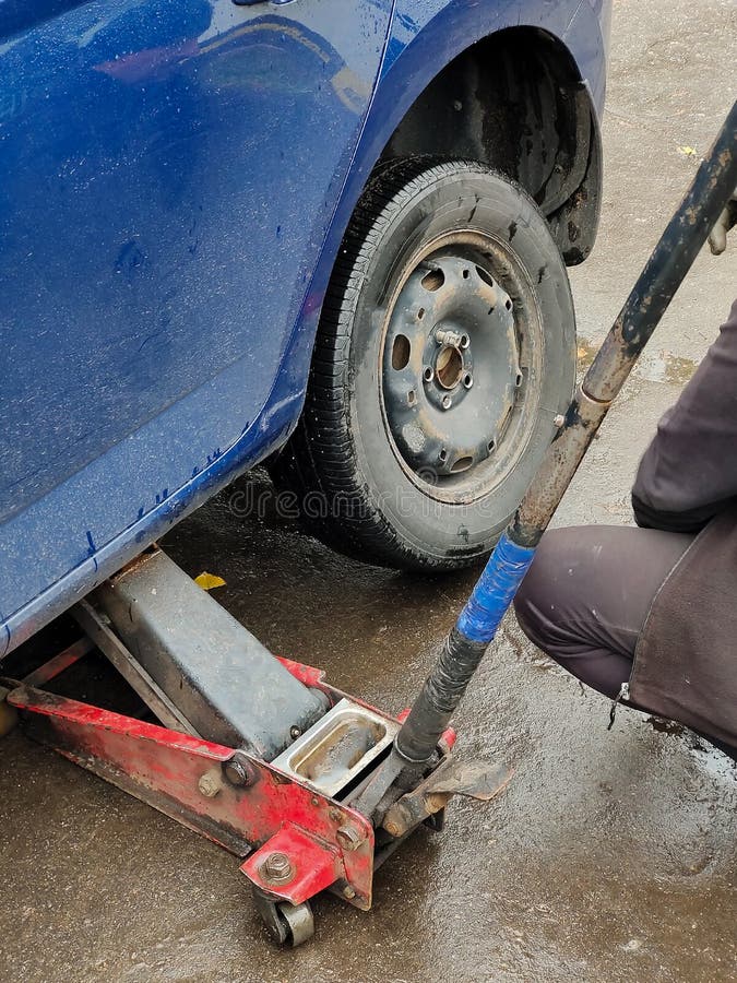 Changing a Wheel on a Car Jack at a Car Service Station Stock Image ...