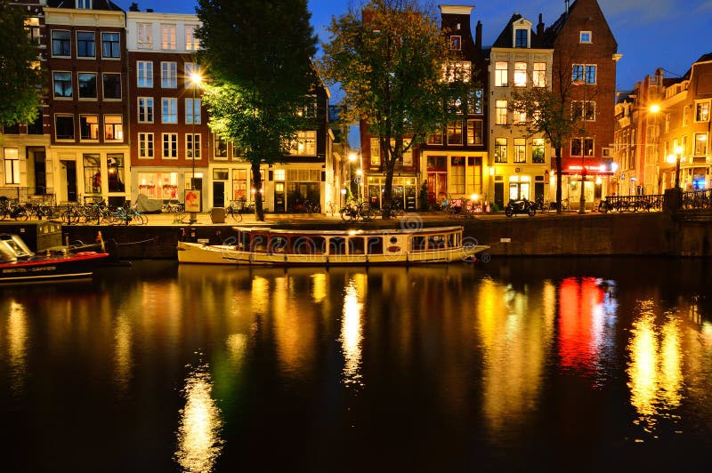 Channels in Amsterdam, the Netherlands Illuminated at Night with ...