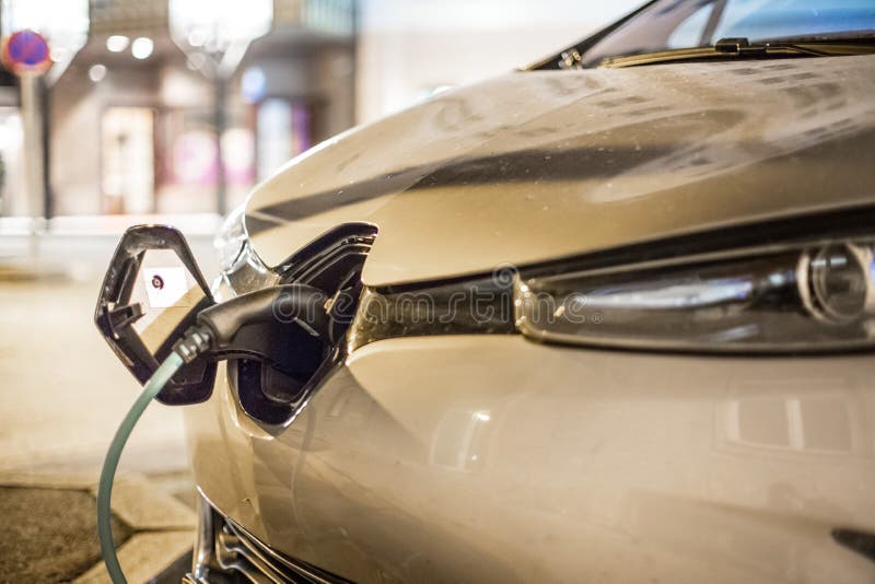 Charching an Electric Car with Power Cable Supply, Plugged in Stock ... Charching an Electric Car with Power Cable Supply, Plugged in Stock ...