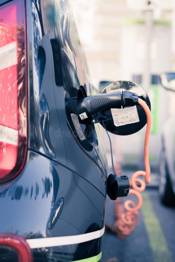 Charching an Electric Car with Power Cable Supply, Plugged in Stock ... Charching an Electric Car with Power Cable Supply, Plugged in Stock ...