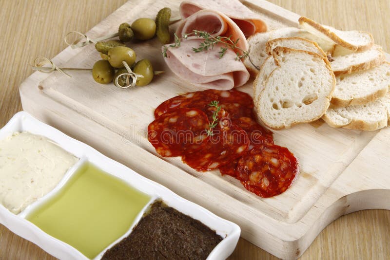 Charcuterie Board with Cold Cuts, Olives, Bread and Dips Stock Image ...