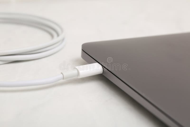 Charge Cable Connected To Laptop on Light Table, Closeup Stock Image ...