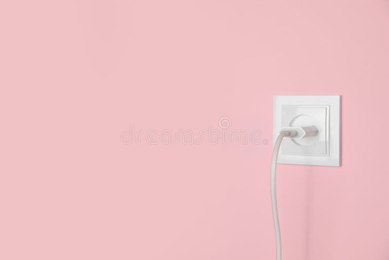 Charger Adapter Plugged into Power Socket on Pink Wall, Space for Text ...
