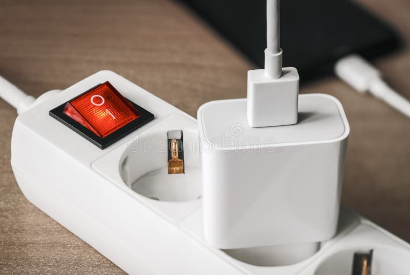A Charger Adapter with a USB Cable Connected To a Power Supply with a ...