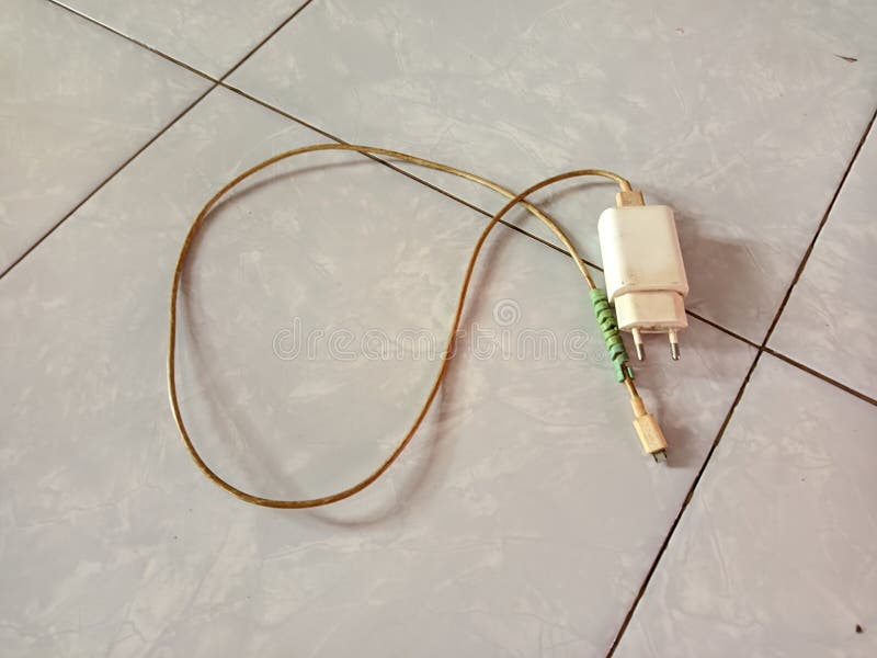 A Charger Consisting of an Adapter and a Cable Lying on the Floor Stock ...