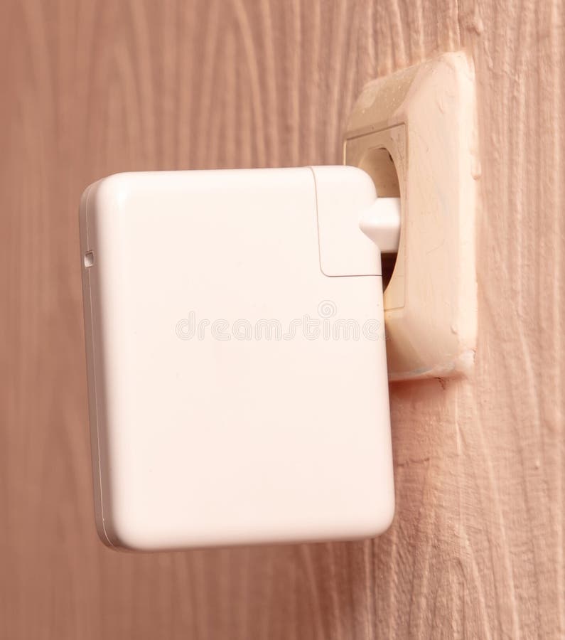 The Charging Adapter Hangs in a Socket on the Wall Stock Photo - Image ...