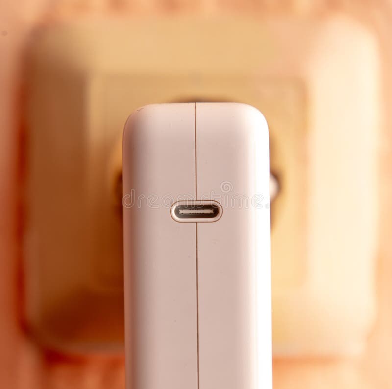 The Charging Adapter Hangs in a Socket on the Wall Stock Image - Image ...