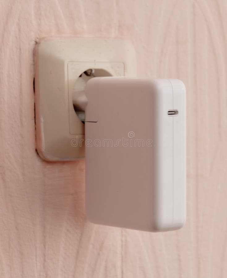 The Charging Adapter Hangs in a Socket on the Wall Stock Photo - Image ...