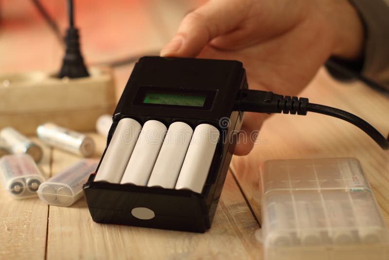 Charging the Battery with a Charger Standing on the Table Stock Photo ...