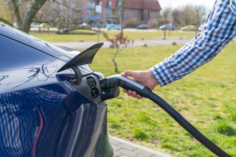 The Charging Cable is Plugged into an Electric Car Stock Photo - Image ...