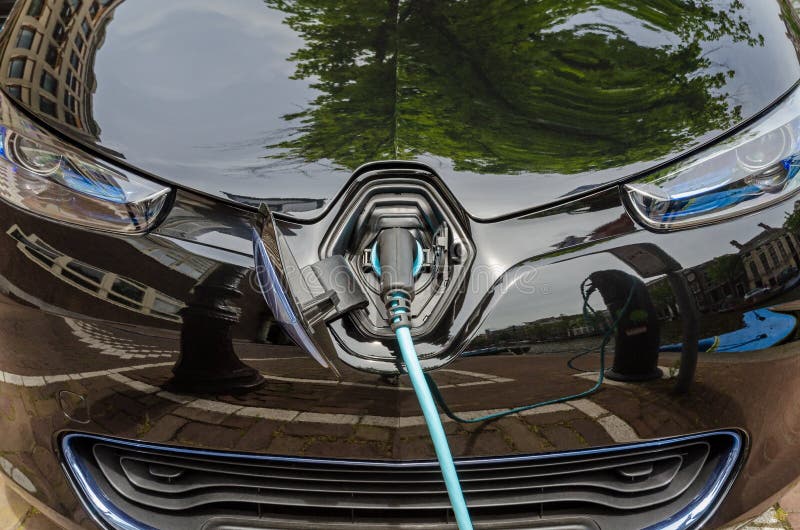 Charging Modern Electric Car with Power Supply Plugged in Stock Photo ...