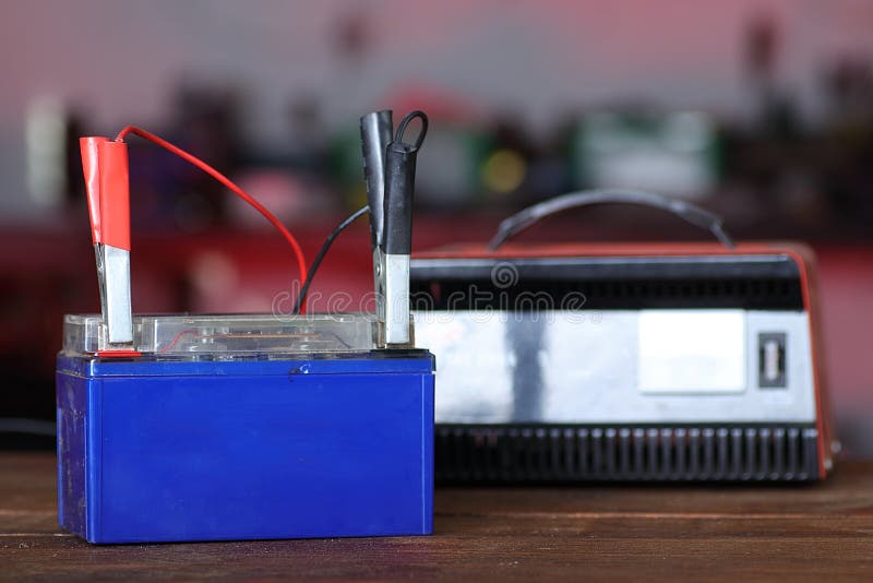 Charging a Small Battery from the Scooter Stock Image - Image of plus ...