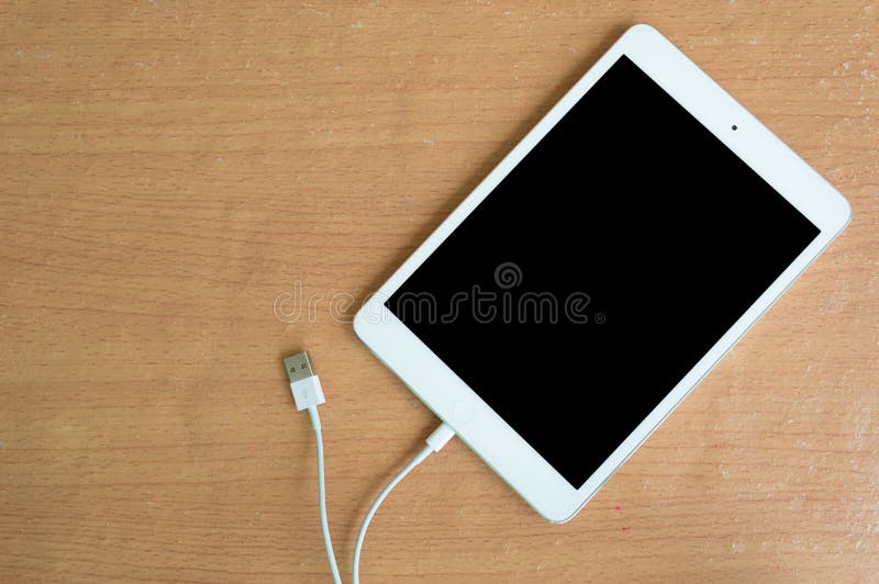 Charging Tablet on Wood Desk Stock Image - Image of computer, efficient ...