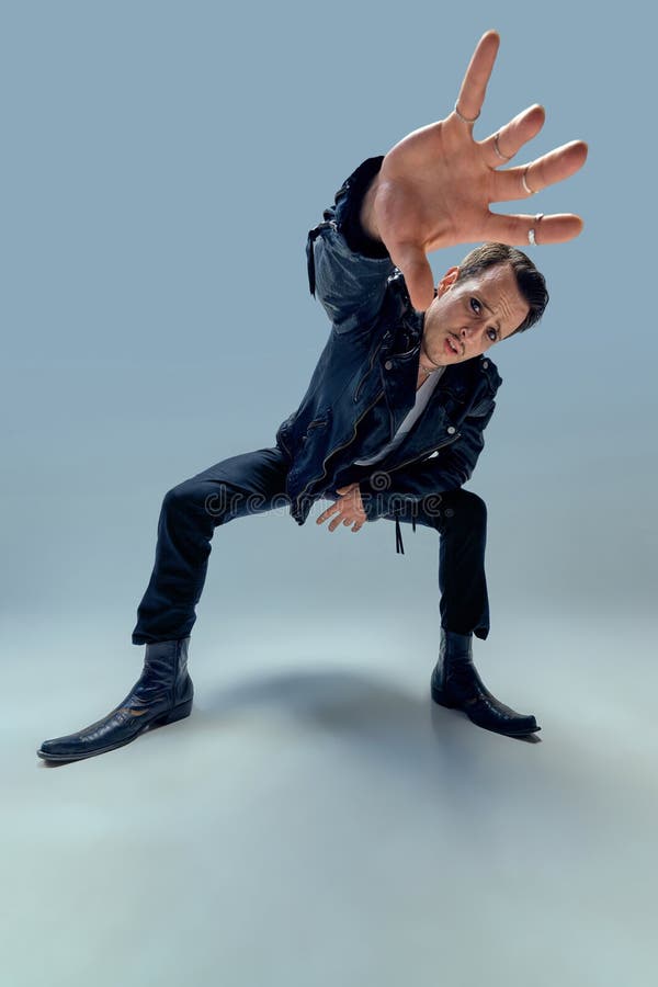 Charismatic Performer Reaching Forward with Intense Gaze and Dynamic ...