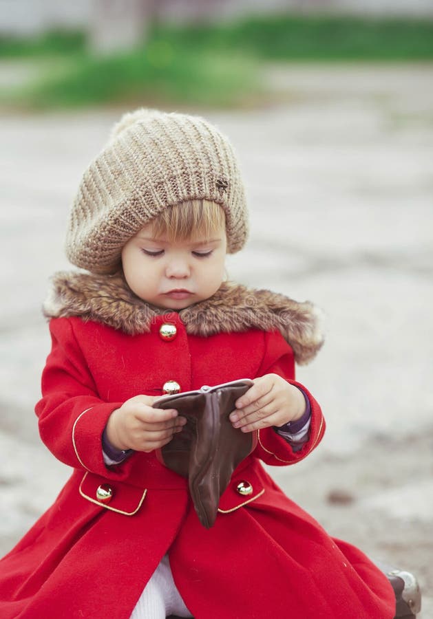 Charming Baby in a Red Coat with a Suitcase is Waiting for a Train on ...