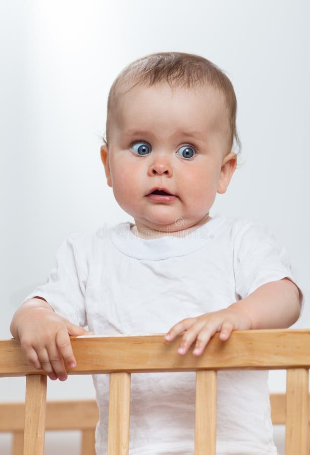 Charming Baby in Rose Dress Playing with Baby Clothes Stock Photo ...
