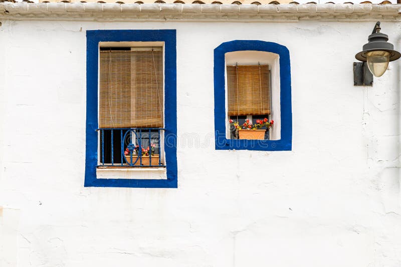 Charming Blue Framed Windows on White Wall Stock Image - Image of town ...