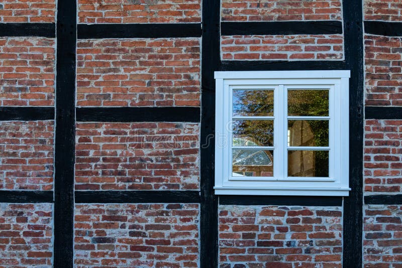 Charming Brick and Timber Frame Wall with a White Window Detail Stock ...