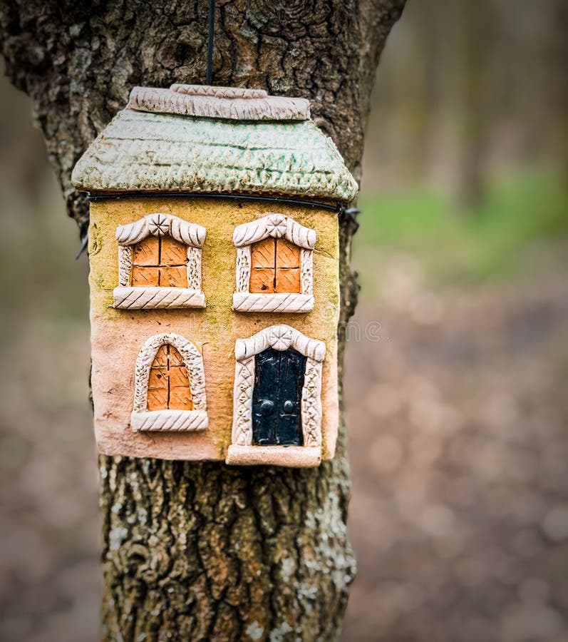 Charming Ceramic Birdhouse Shaped Like a Small House, Attached To a ...