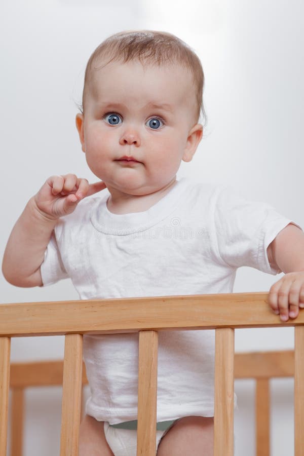 Charming child in the crib stock image. Image of blond - 29247689