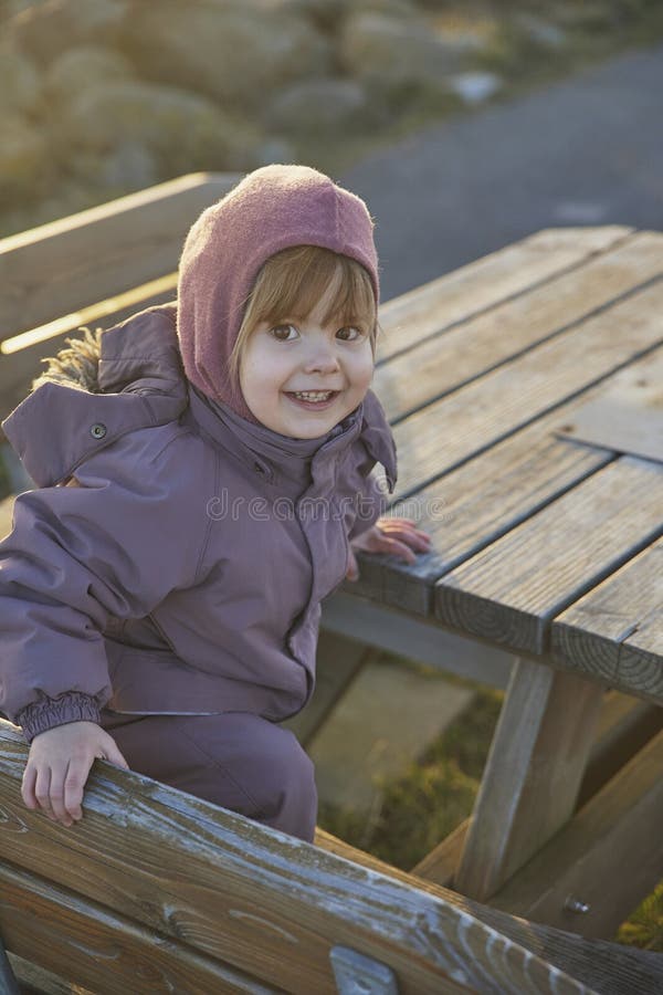 Charming Child Sits at a Picnic Table in Denmark at Sunset Stock Image ...