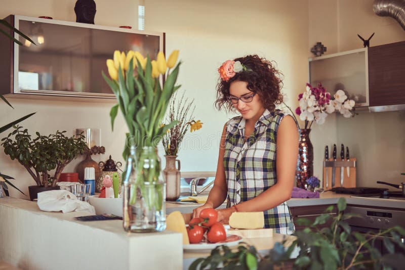 Charming Curly Hispanic Girl Cooking in Her Kitchen. Stock Image ...