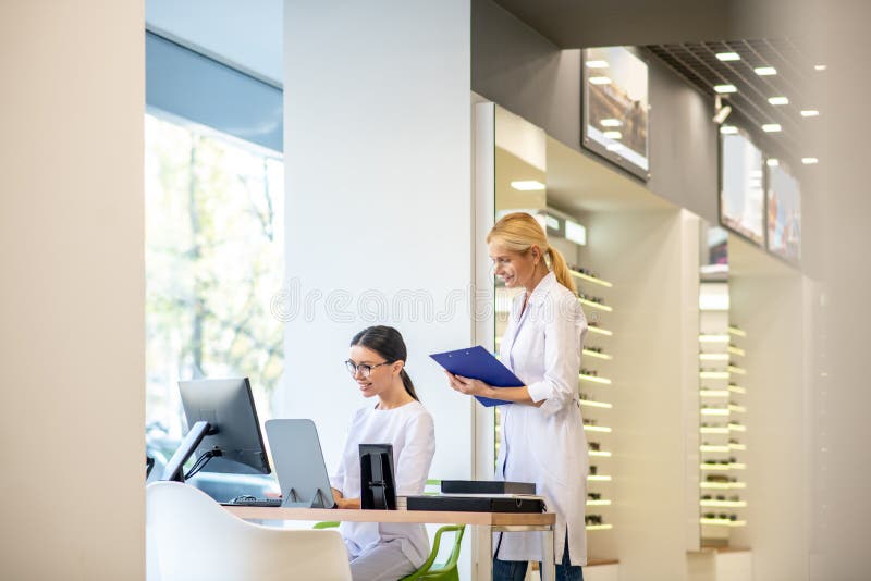 Charming doctors feeling concentrated while doing their work, Working ...