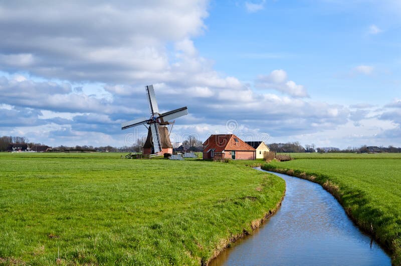 Charming Dutch Windmill on Green Grasslands Stock Image - Image of ...