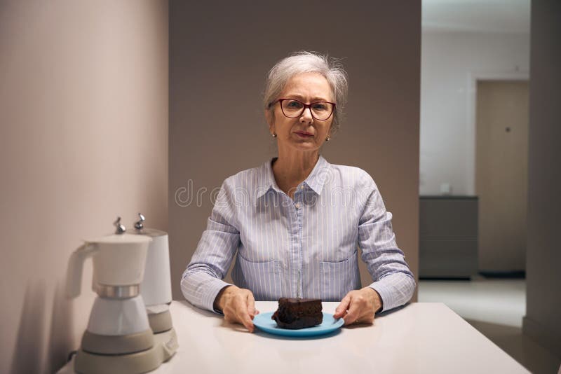 Charming Elderly Lady is Sitting at Table with Piece of Cake Stock ...