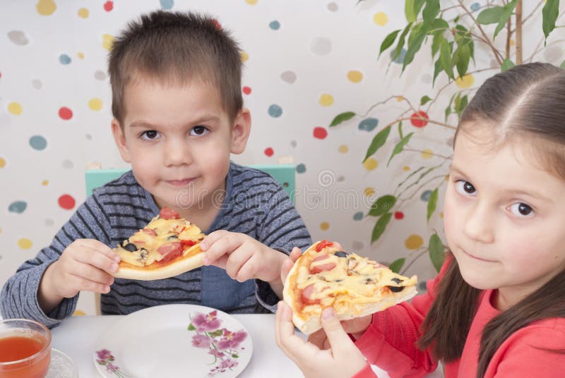 Children eat pizza stock photo. Image of childcare, distribution ...