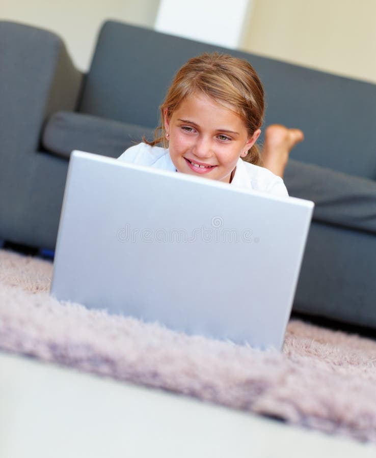 A Charming Girl Lying on Floor with a Laptop Stock Image - Image of ...