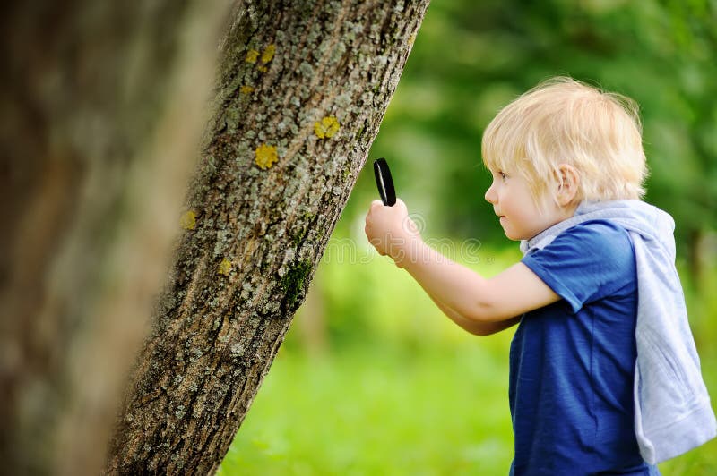 Charming Kid Exploring Nature with Magnifying Glass Stock Photo - Image ... Charming Kid Exploring Nature with Magnifying Glass Stock Photo - Image ...