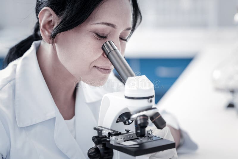 Charming Mature Lady Examining Sample Under Microscope Stock Photo ...