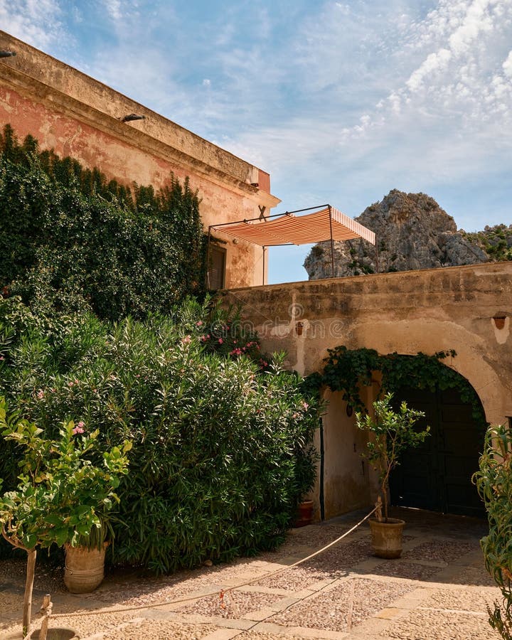 Charming Mediterranean Courtyard with Lush Greenery and Rustic ...