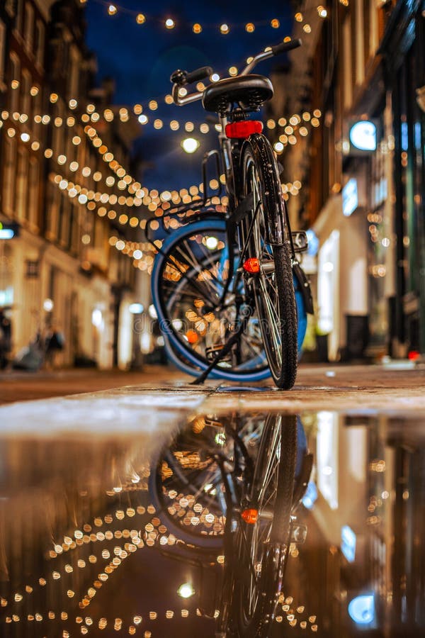 Charming Night Scene of Amsterdam: Bicycle Reflection Under String ...