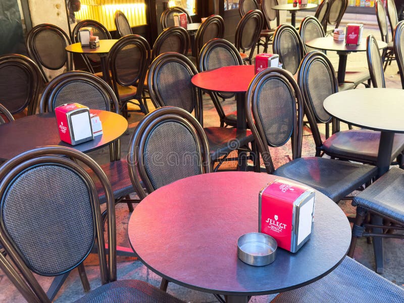 Charming Outdoor Cafe with Round Tables and Chairs for Relaxing Dining ...