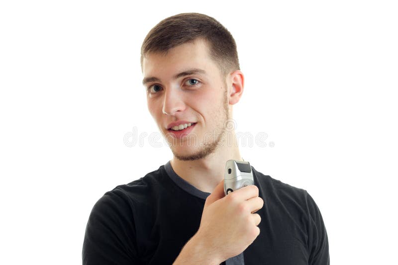 Charming Portrait of a Young Smiling Guy with Shaving Machine in Hand ...