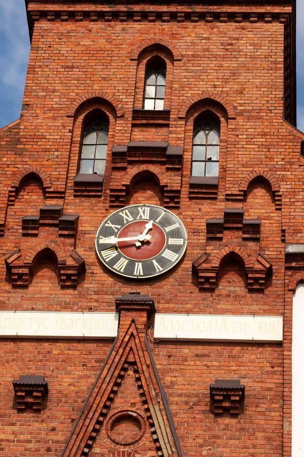 A Tall Red Brick Building Prominently Displays a Clock Indicating 420 ...