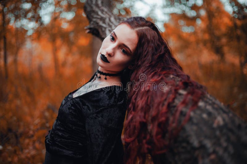 Charming Red-haired Witch in an Autumn Forest with a Magical Atmosphere ...