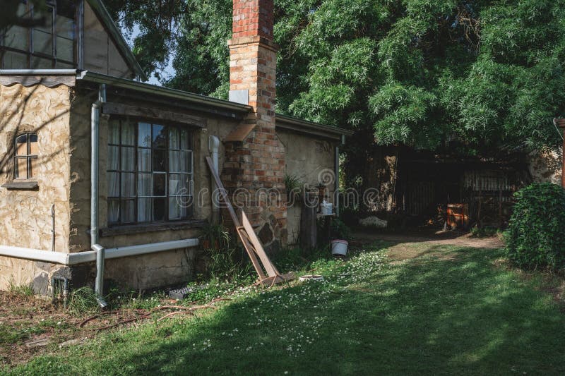 Rustic Cottage with Brick Chimney and Greenery. Stock Image - Image of ...