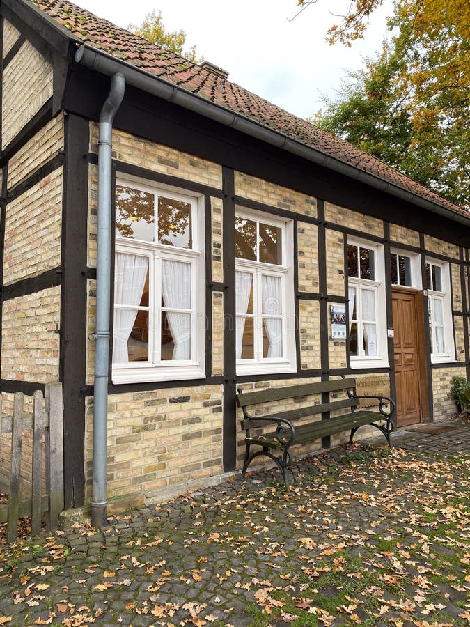 Charming Rustic House with a Bench on a Cobblestone Path in an Autumn ...